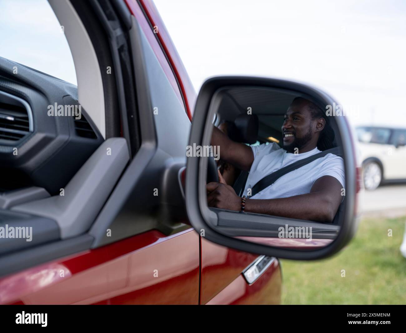 Reflection of man in rear view mirror Stock Photo - Alamy