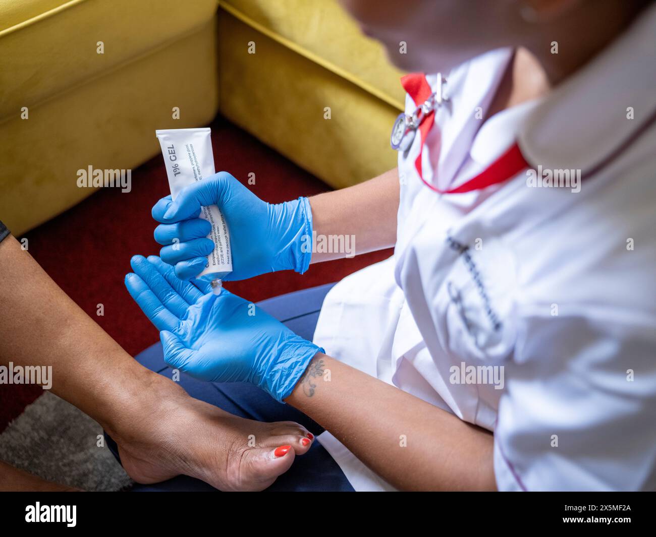 Nurse taking care of womans foot Stock Photo - Alamy