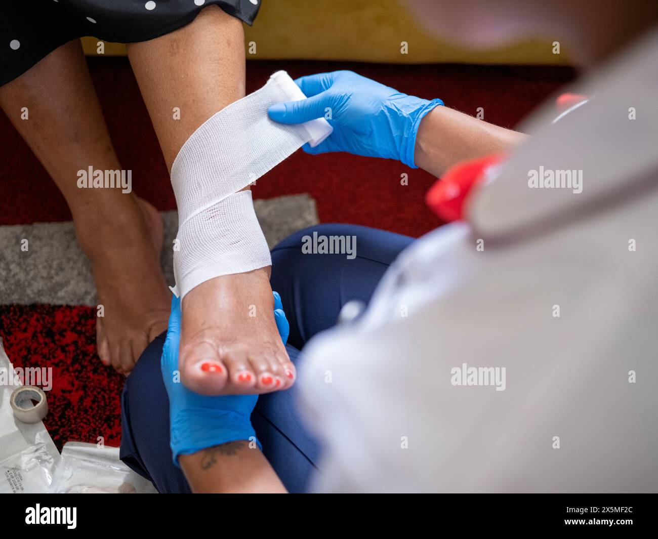 Nurse taking care of patients foot Stock Photo - Alamy