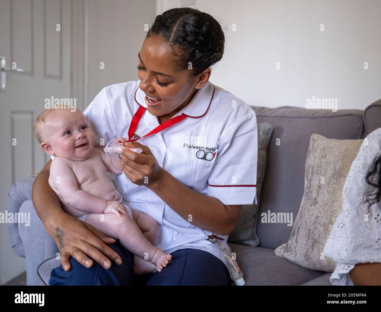 Nurse taking care of baby girl (2-5 months Stock Photo - Alamy