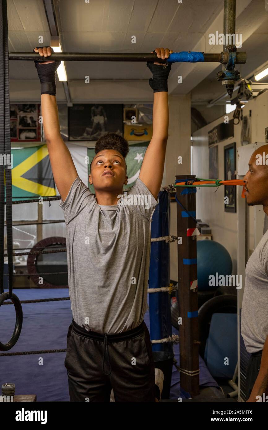 Young woman guided by coach during gym training Stock Photo - Alamy
