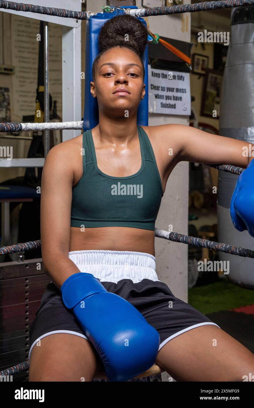 Young woman resting in corner of boxing ring Stock Photo - Alamy