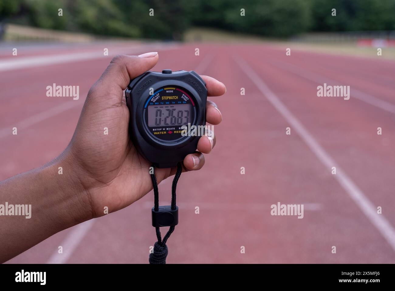 Close-up of hand holding stopwatch at running track Stock Photo - Alamy