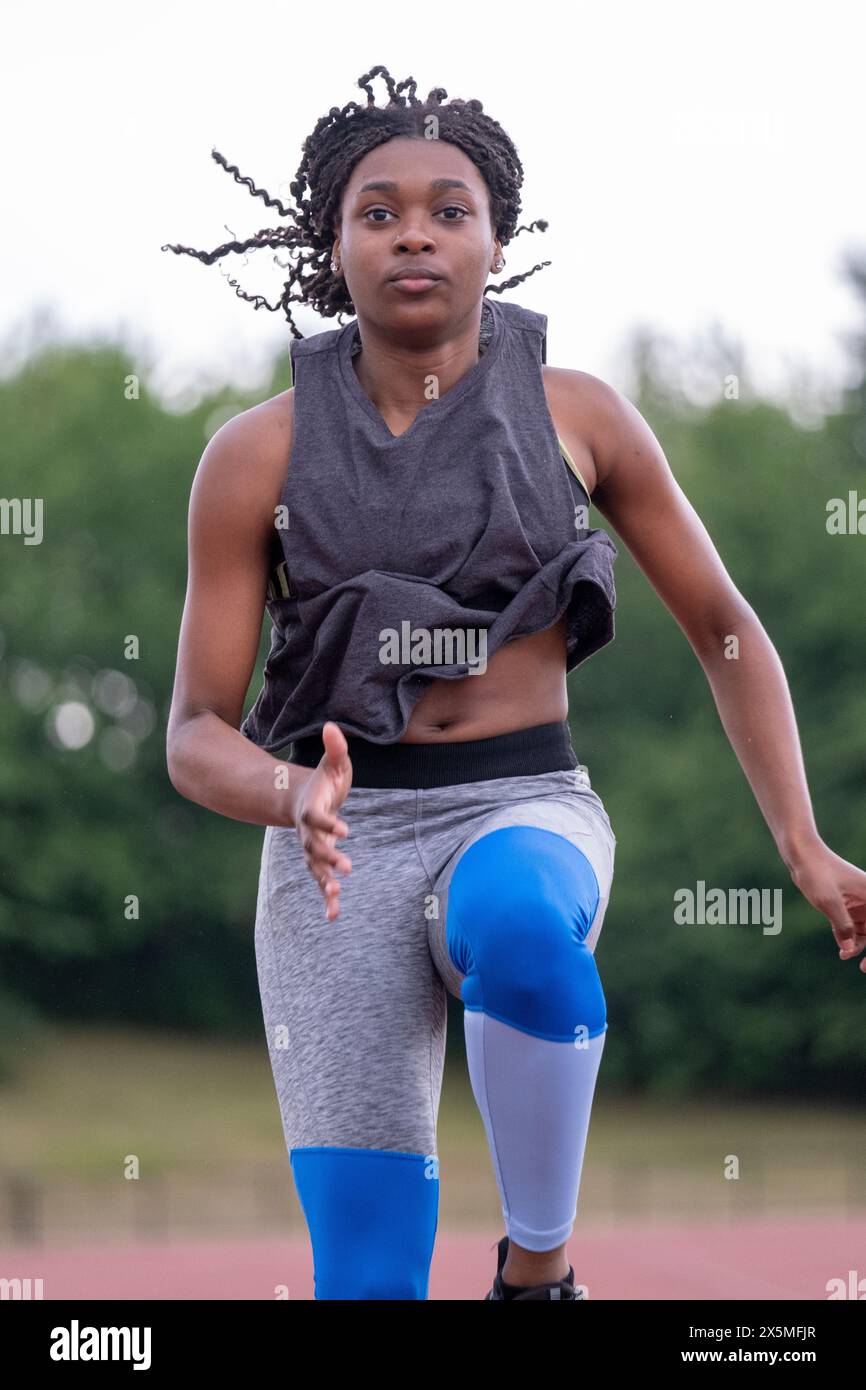 Athletic woman running on track Stock Photo - Alamy