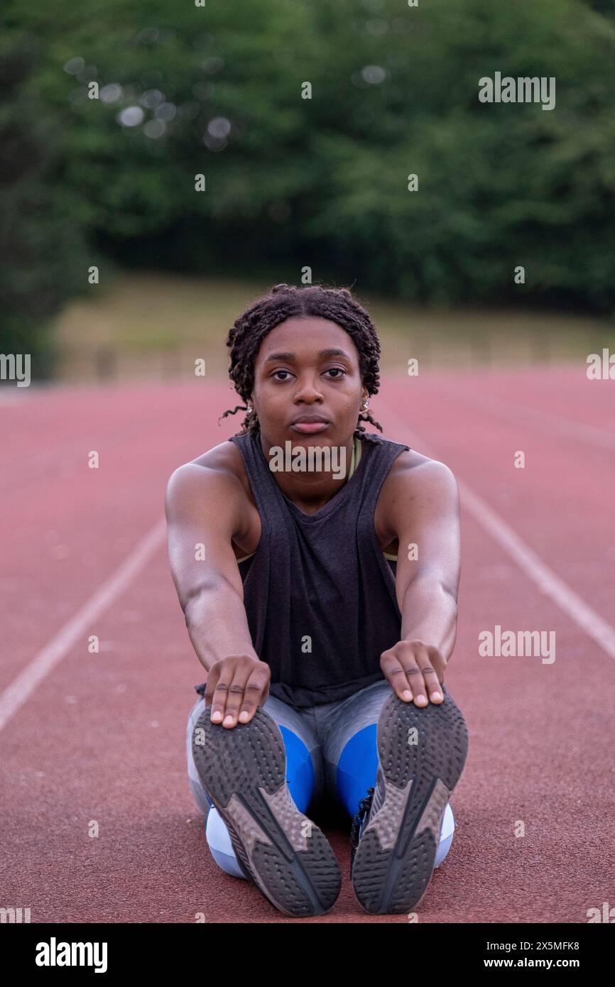 Athletic young woman stretching legs hi-res stock photography and ...