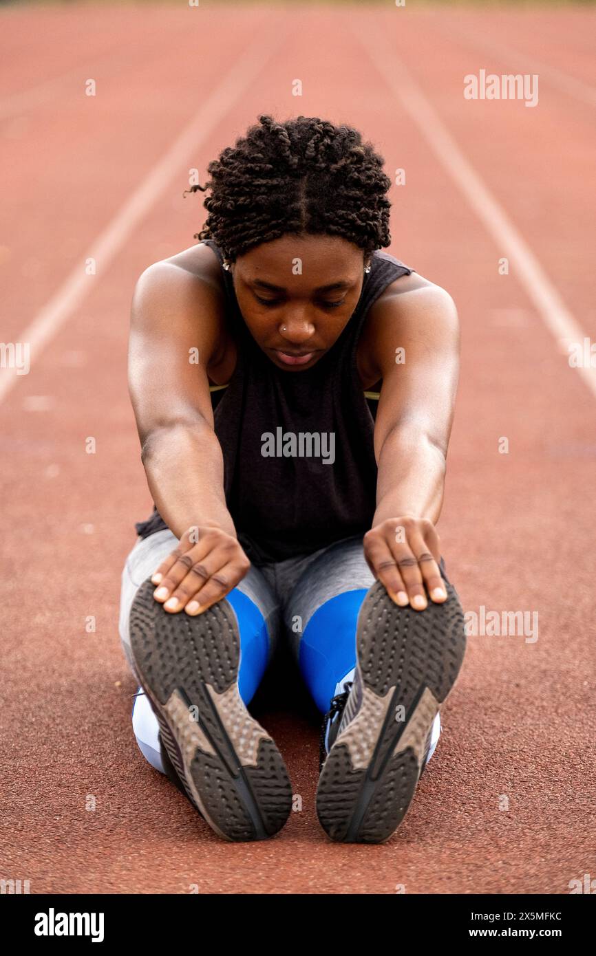 Athletic young woman stretching legs hi-res stock photography and ...