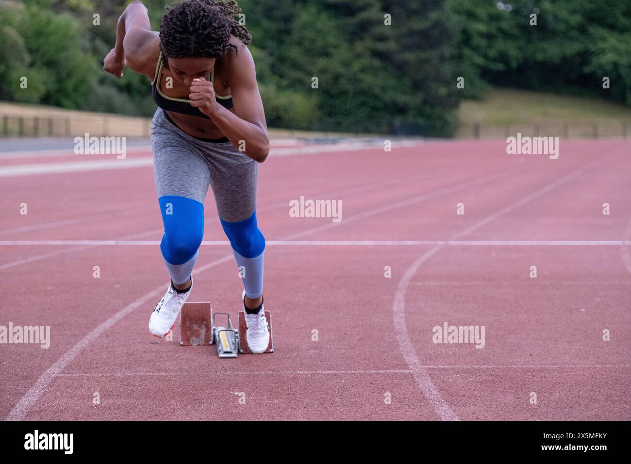 Athletic woman on running track Stock Photo - Alamy