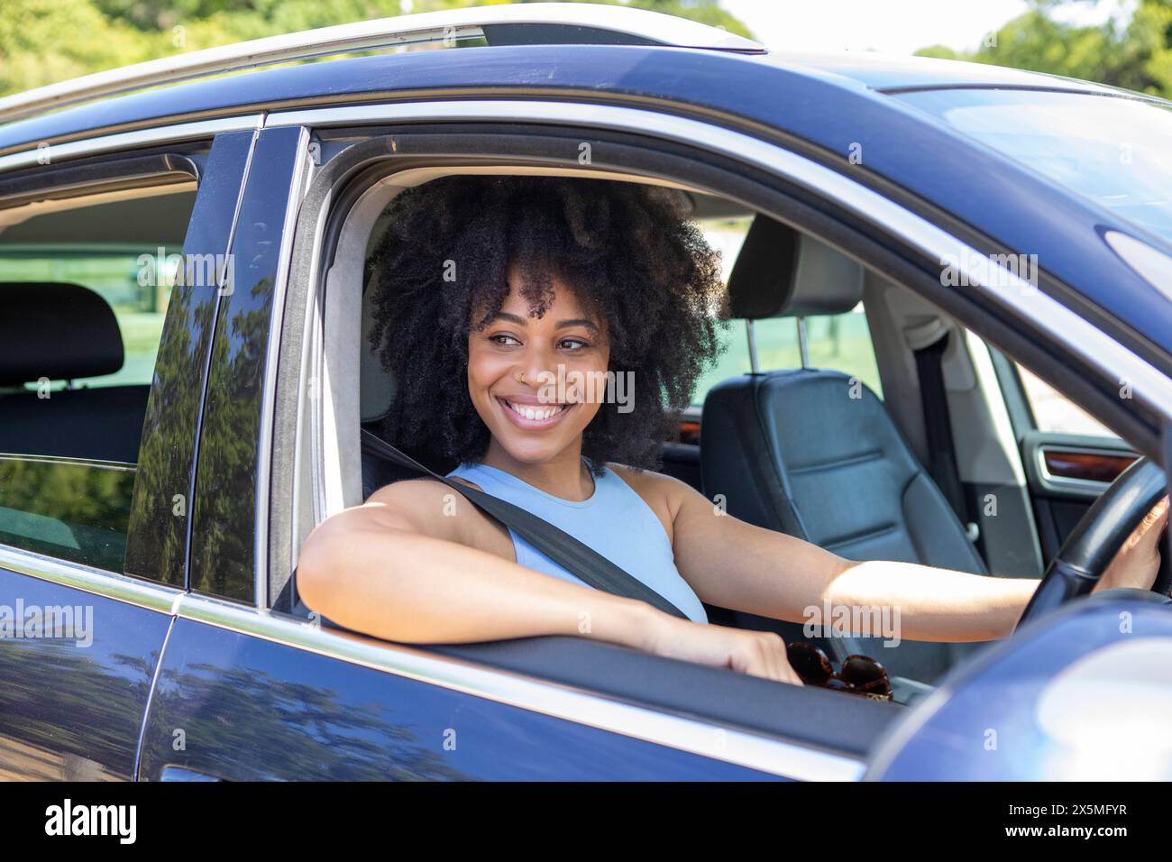 Young woman driving car Stock Photo - Alamy