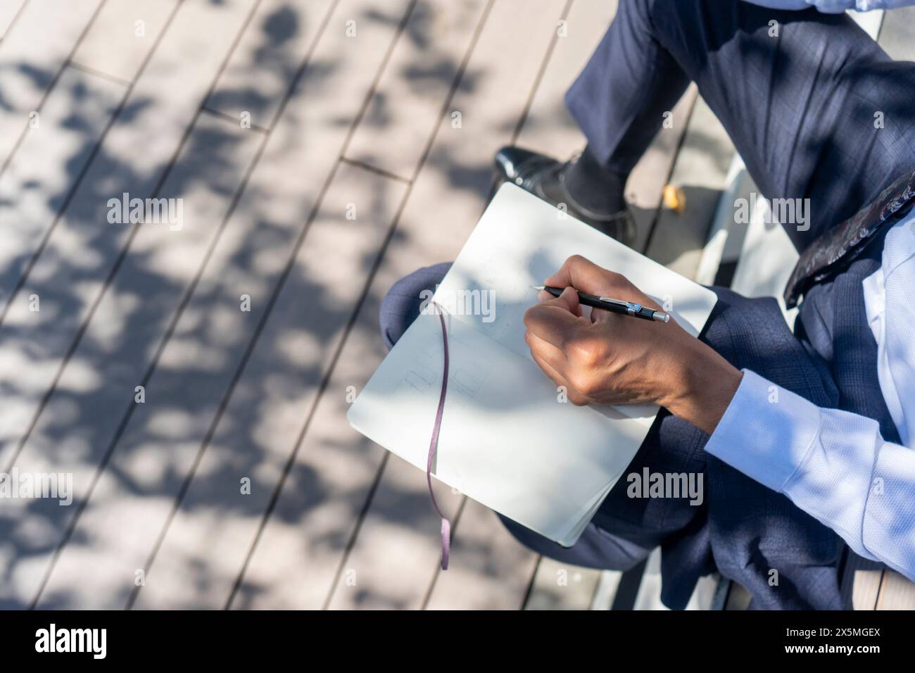 Businessman taking notes outdoors Stock Photo - Alamy