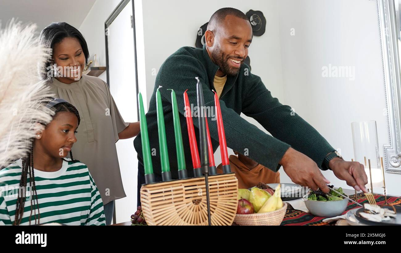 Family with children (8-9, 12-13) having Kwanzaa meal Stock Photo - Alamy