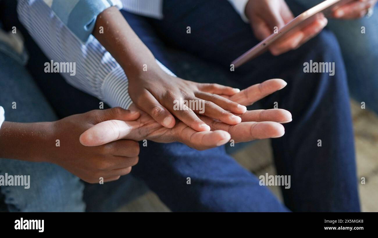 Father and son (8-9) comparing hand sizes Stock Photo - Alamy