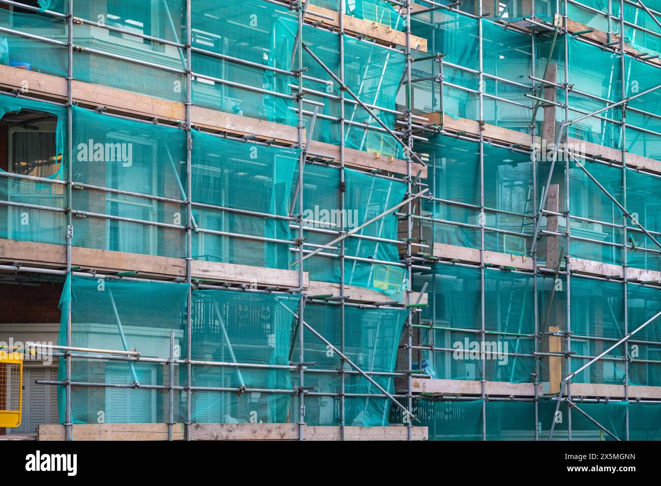 Scaffolding with debris netting on London street, England Stock Photo ...