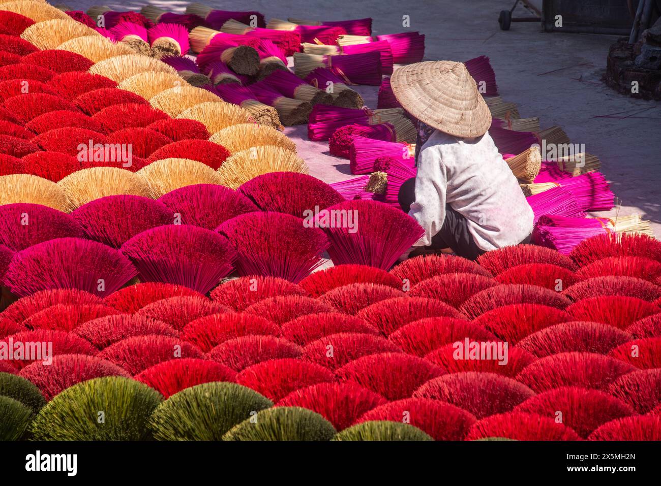 Worker drying incense in the Quang Phu Cau incense village, Hanoi ...