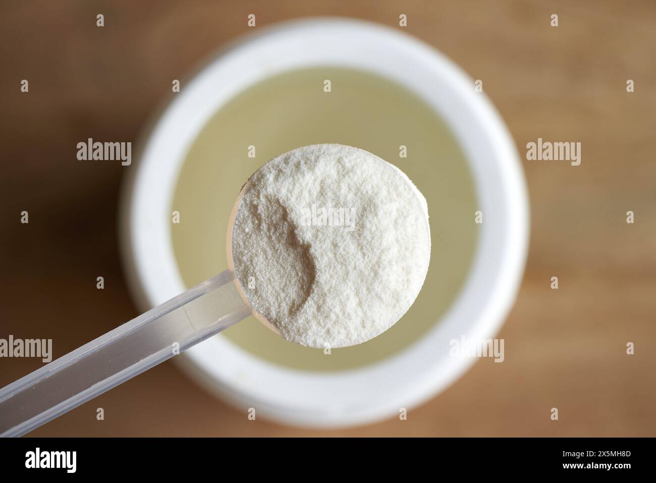Collagen powder in a plastic measuring spoon above a jar Stock Photo ...