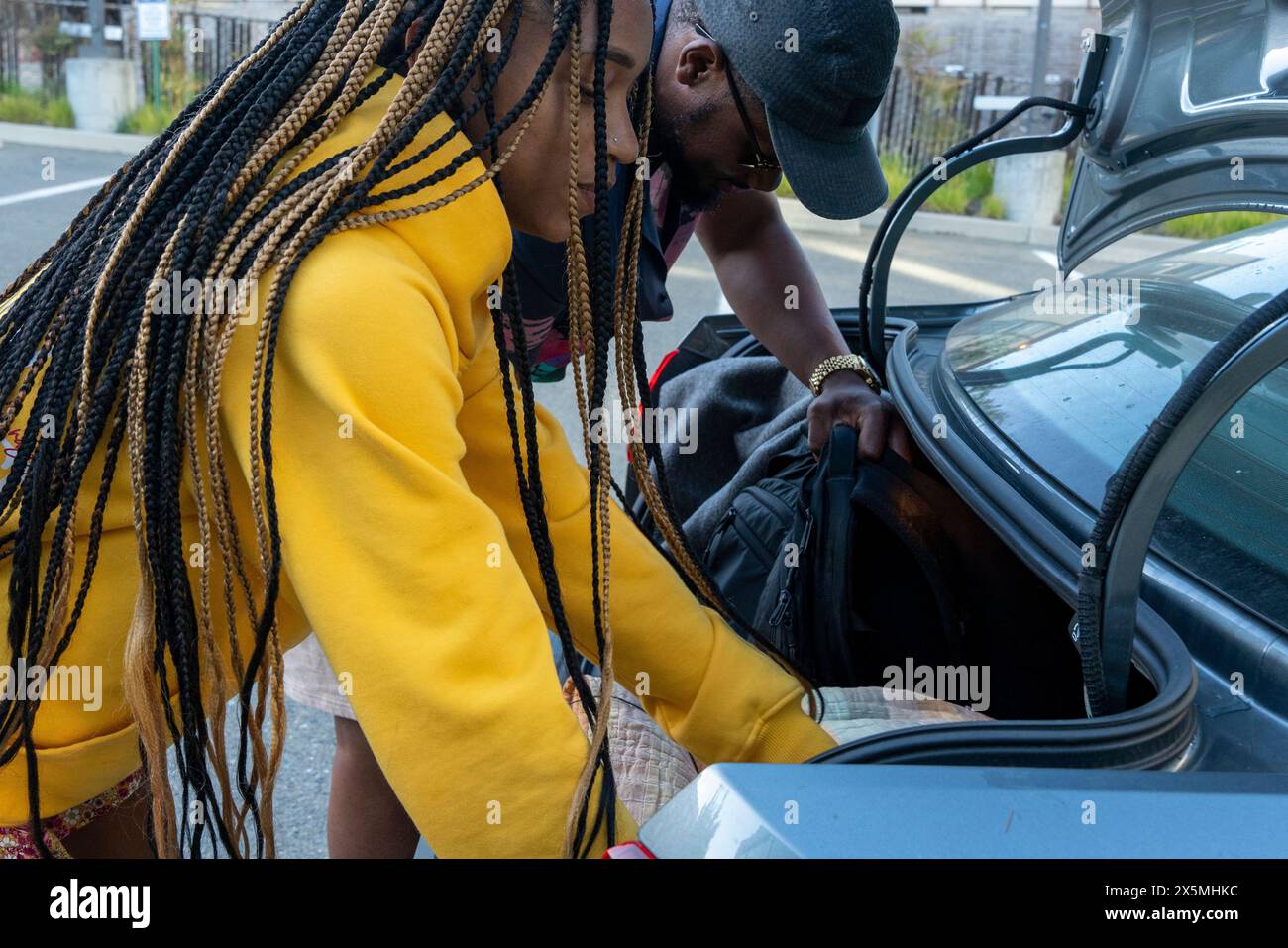 Couple checking luggage in car trunk on road trip Stock Photo - Alamy