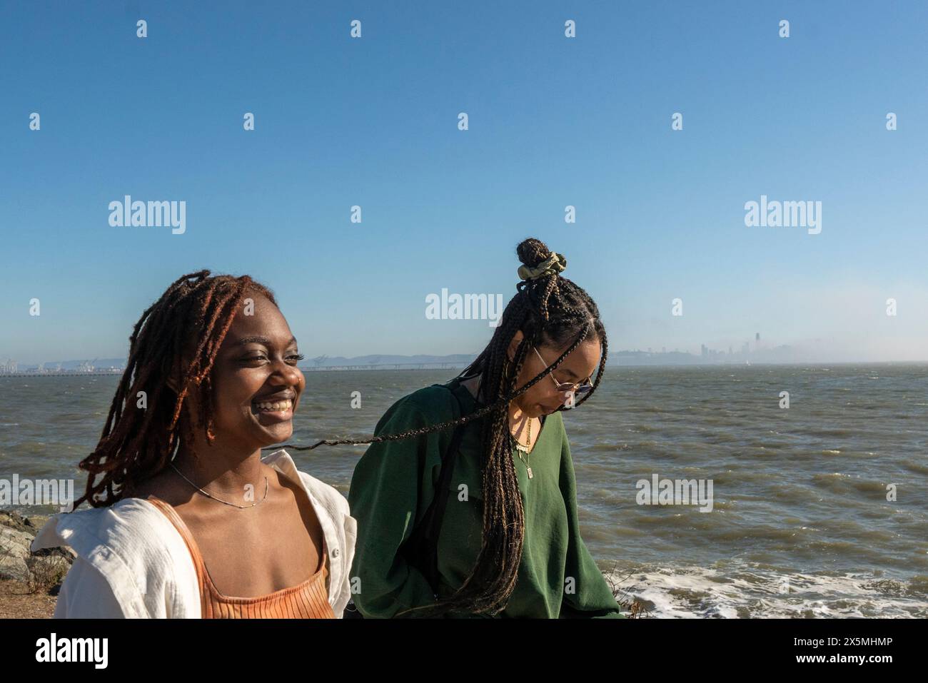 Female friends on seaside stroll Stock Photo - Alamy