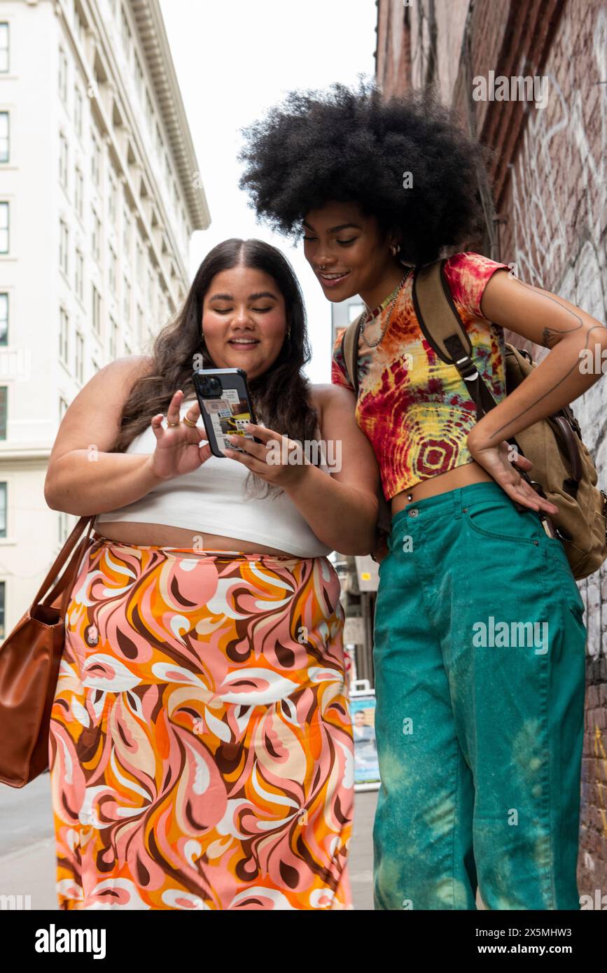 Two women using technology hi-res stock photography and images - Alamy