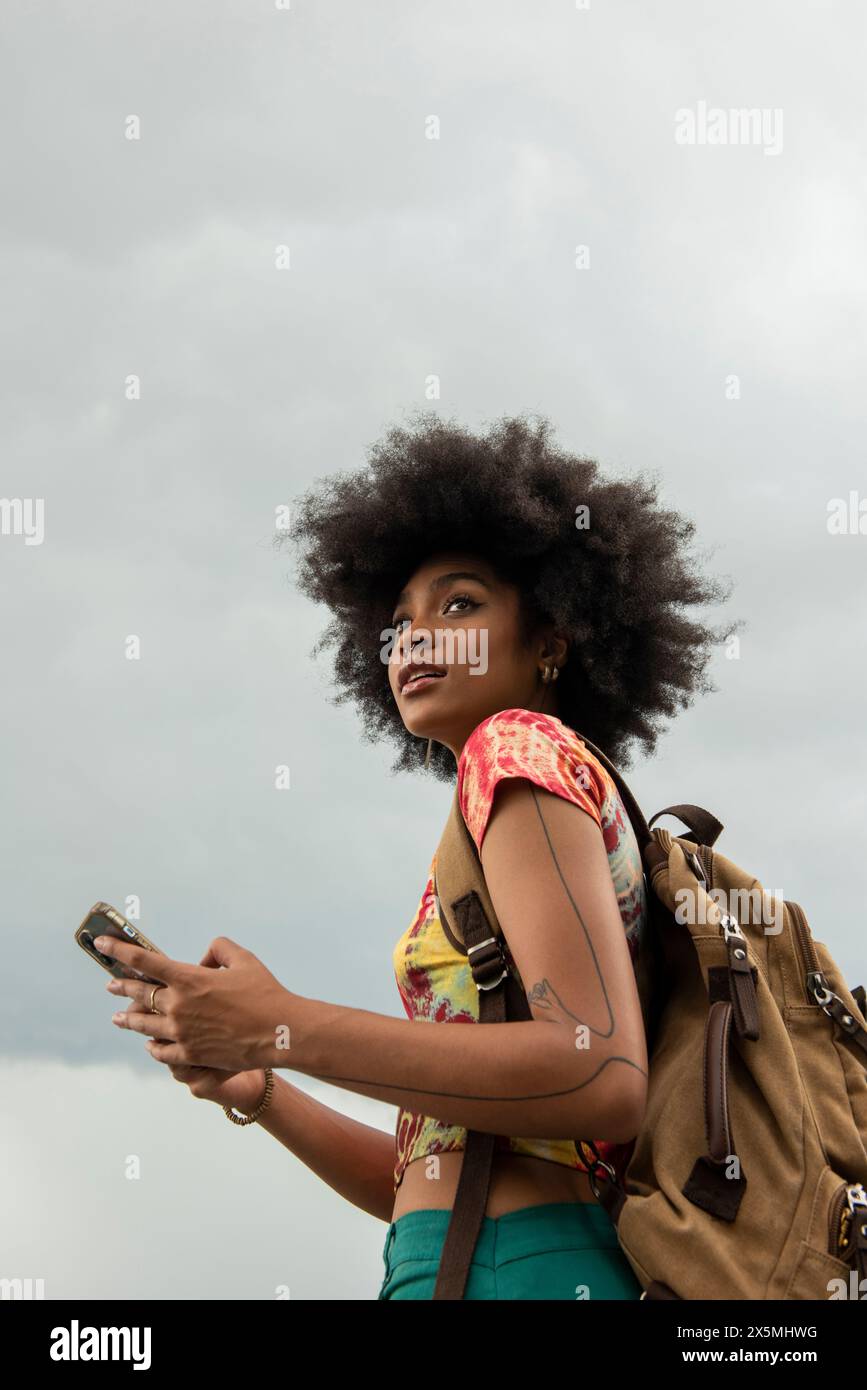 Afro woman using backpack hi-res stock photography and images - Alamy