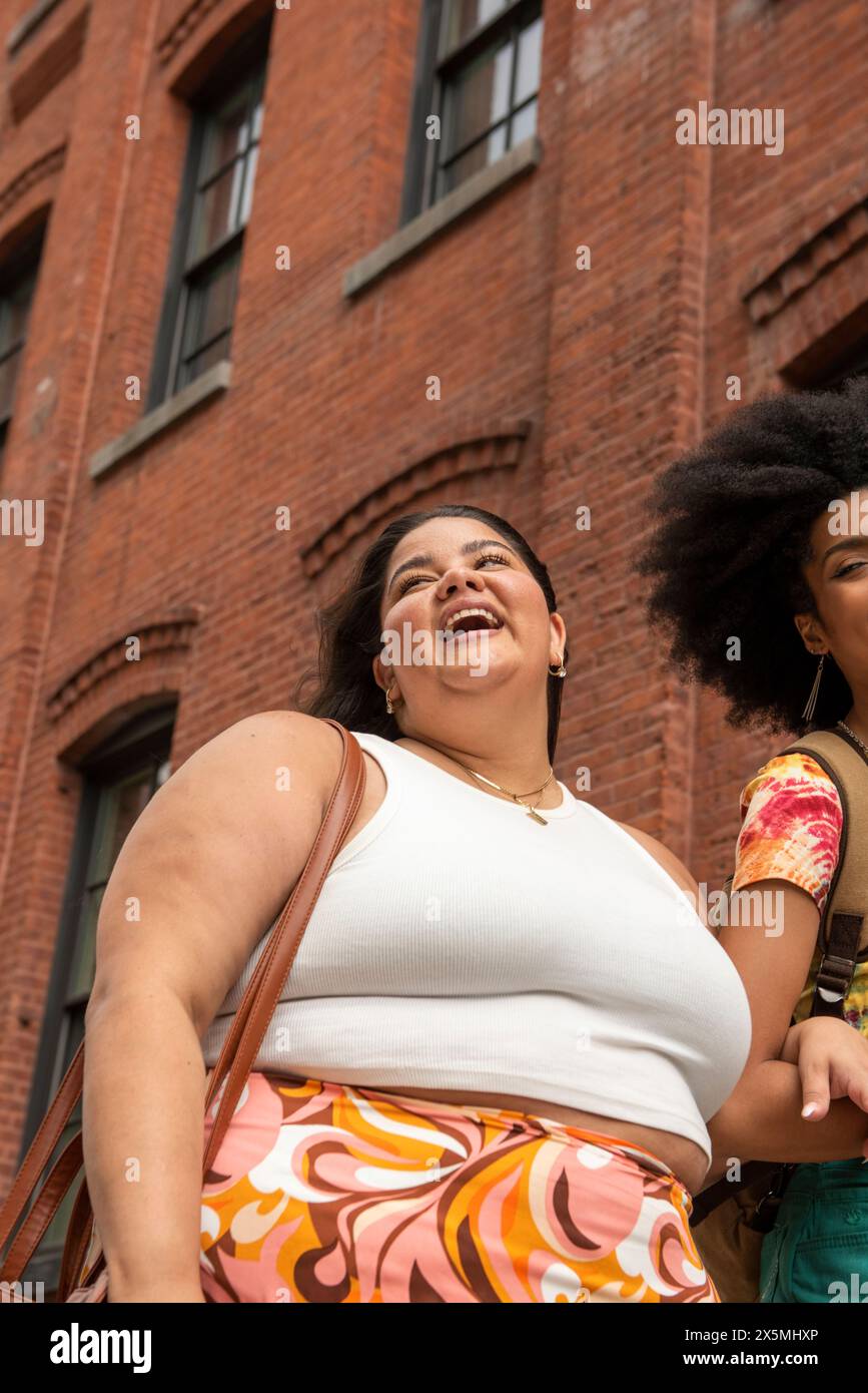 Two women in front of brick building Stock Photo - Alamy