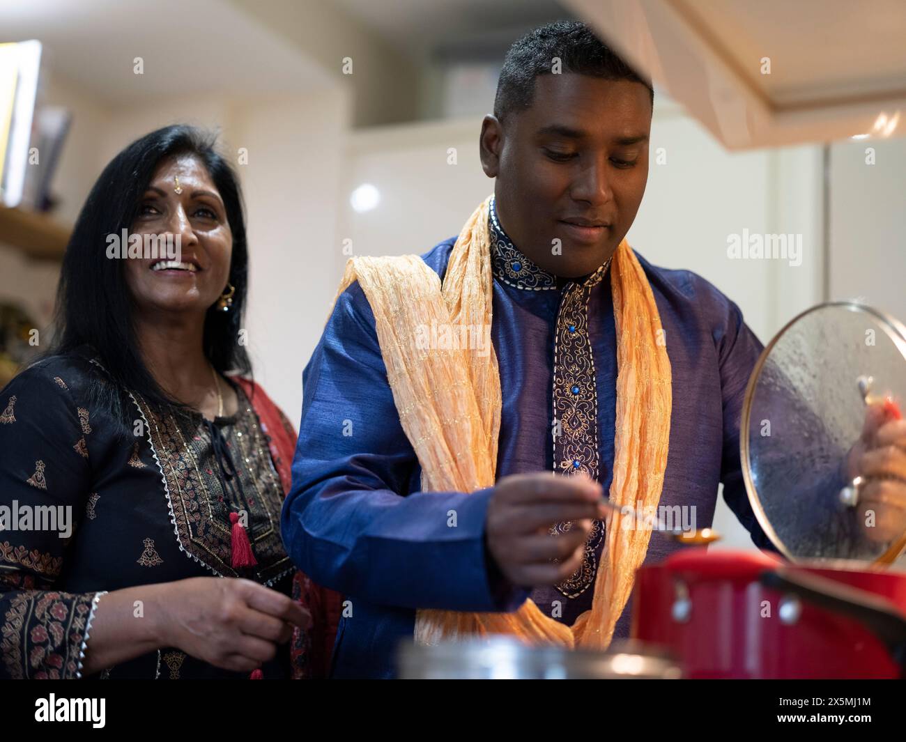 Mother and son cooking food for Diwali celebration Stock Photo - Alamy
