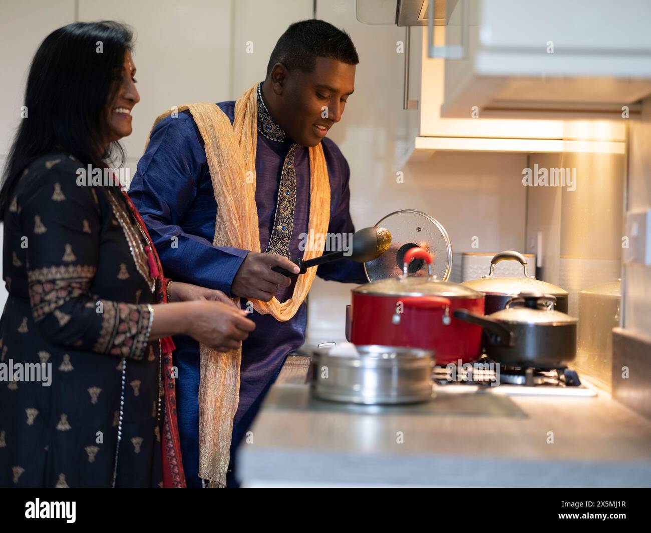 Mother and son cooking food for Diwali celebration Stock Photo - Alamy