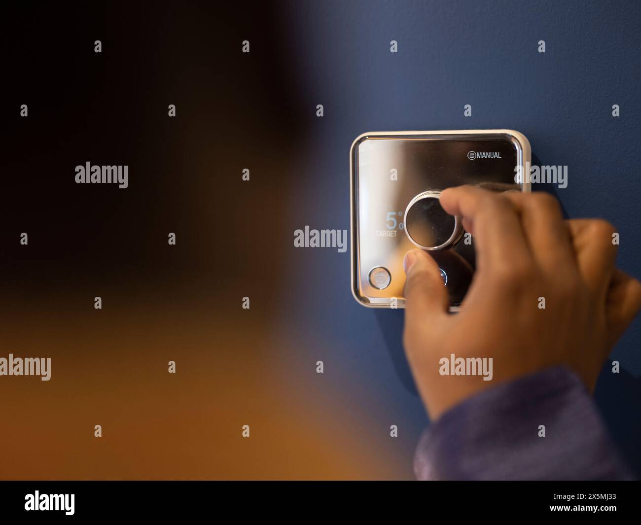 Man using thermostat at home Stock Photo - Alamy