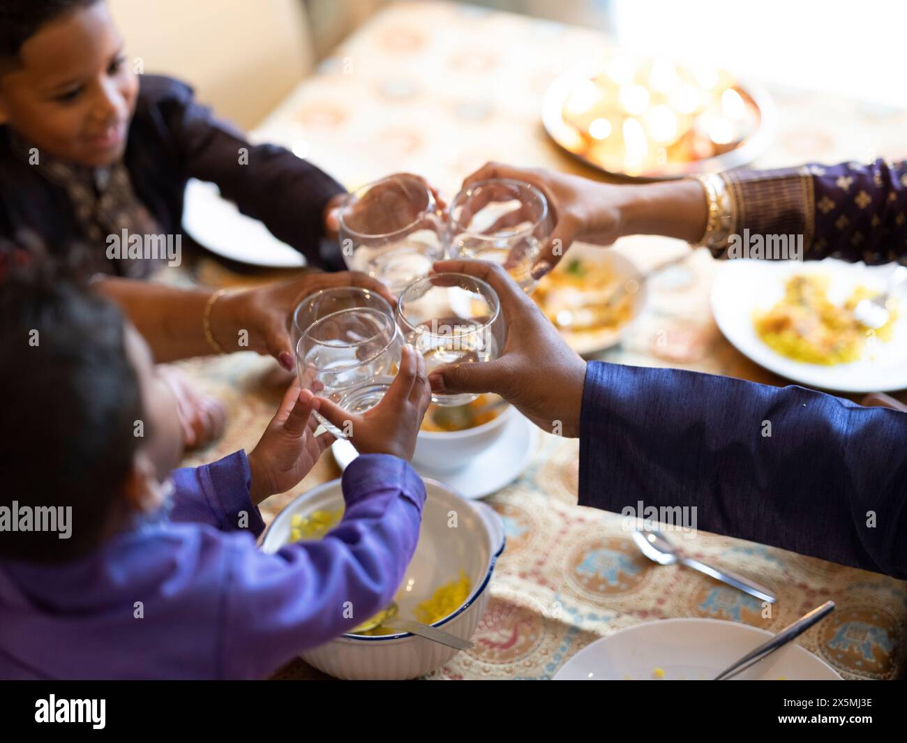 Family raising toast at Diwali dinner Stock Photo - Alamy