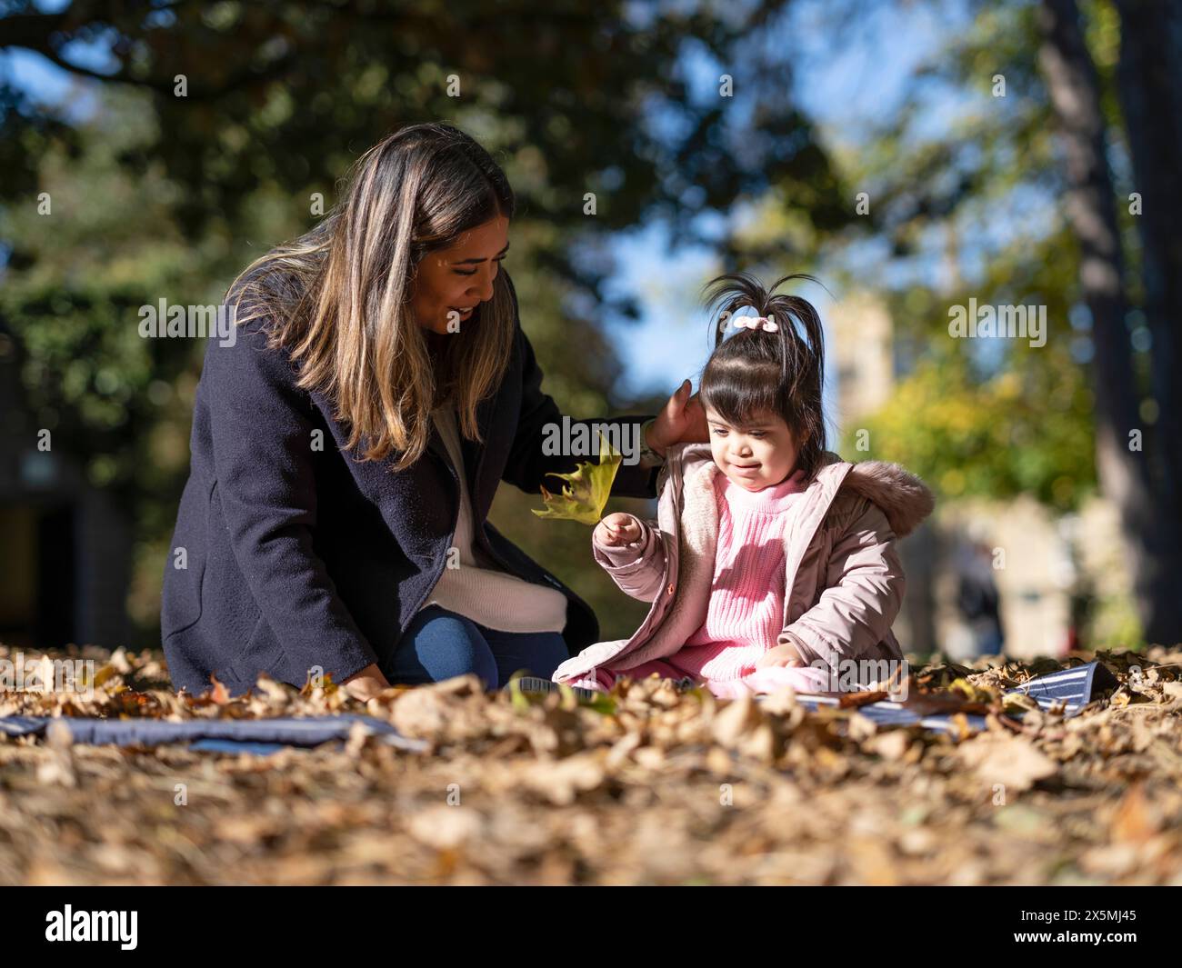 Mother and daughter with Down syndrome playing in park Stock Photo - Alamy