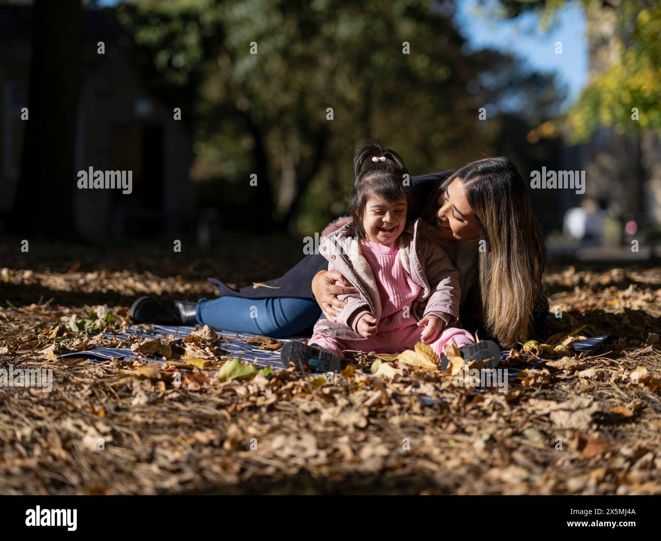 Mother and daughter with Down syndrome playing in park Stock Photo - Alamy