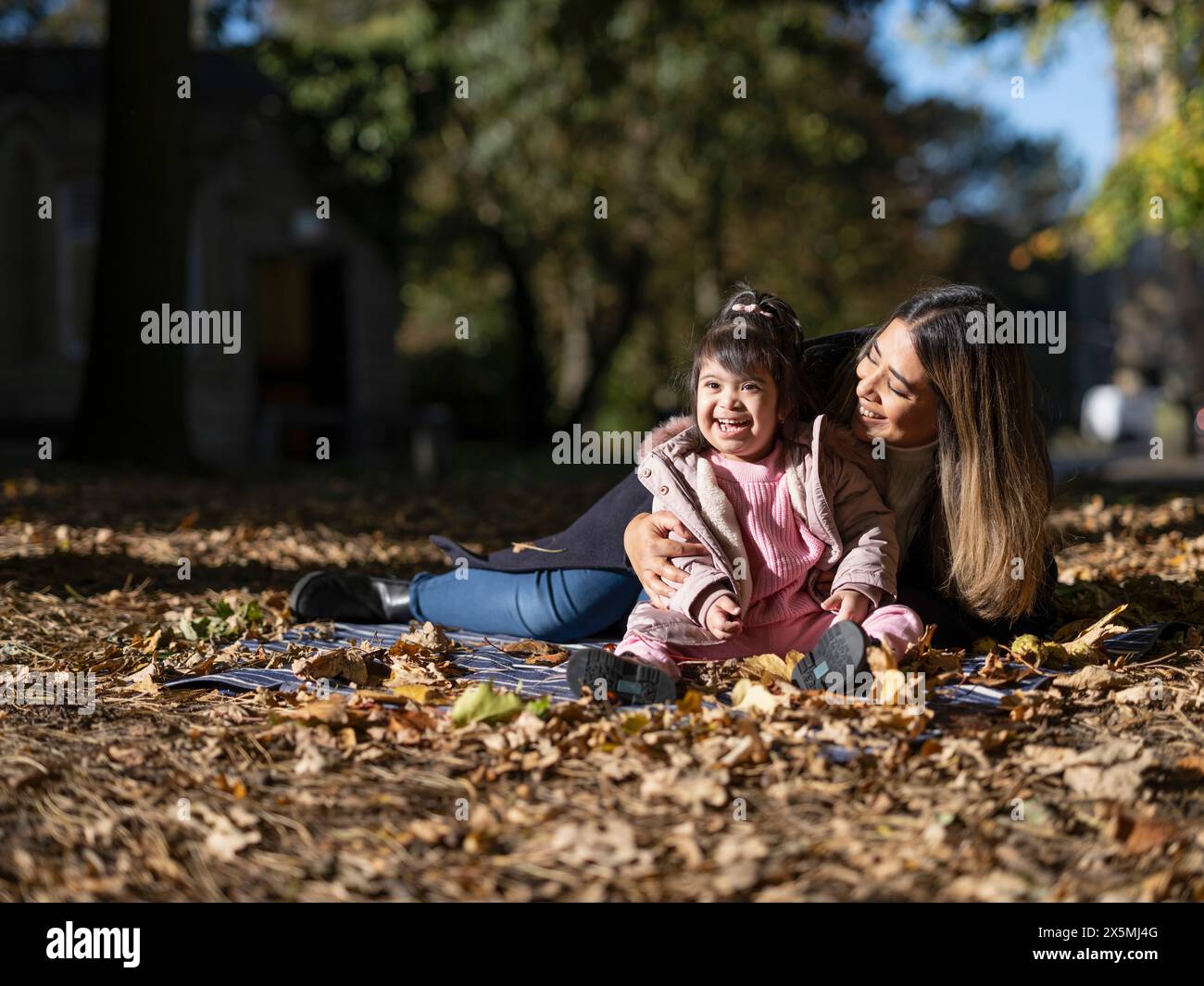 Mother and daughter with Down syndrome playing in park Stock Photo - Alamy