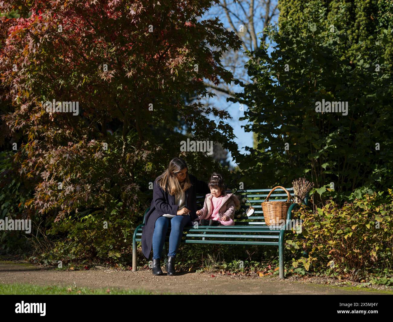 Mother and daughter with Down syndrome sitting on bench Stock Photo - Alamy