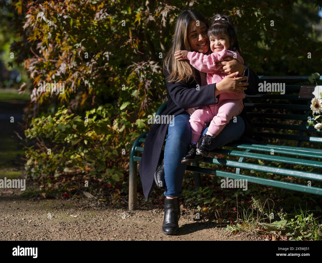 Mother and daughter with Down syndrome hugging on bench Stock Photo - Alamy
