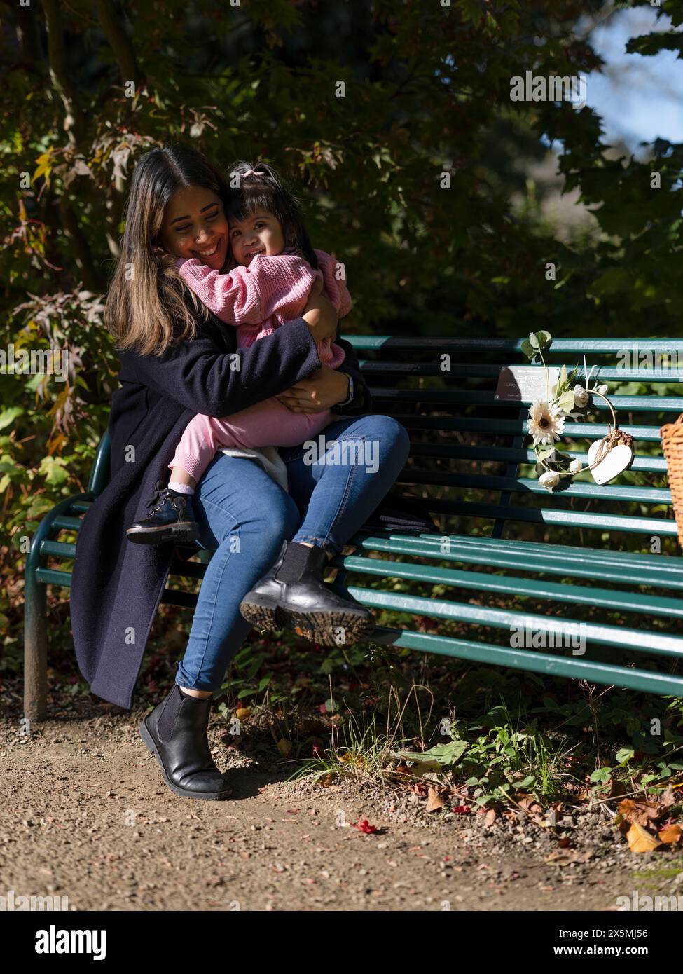 Mother and daughter with Down syndrome hugging on bench Stock Photo - Alamy