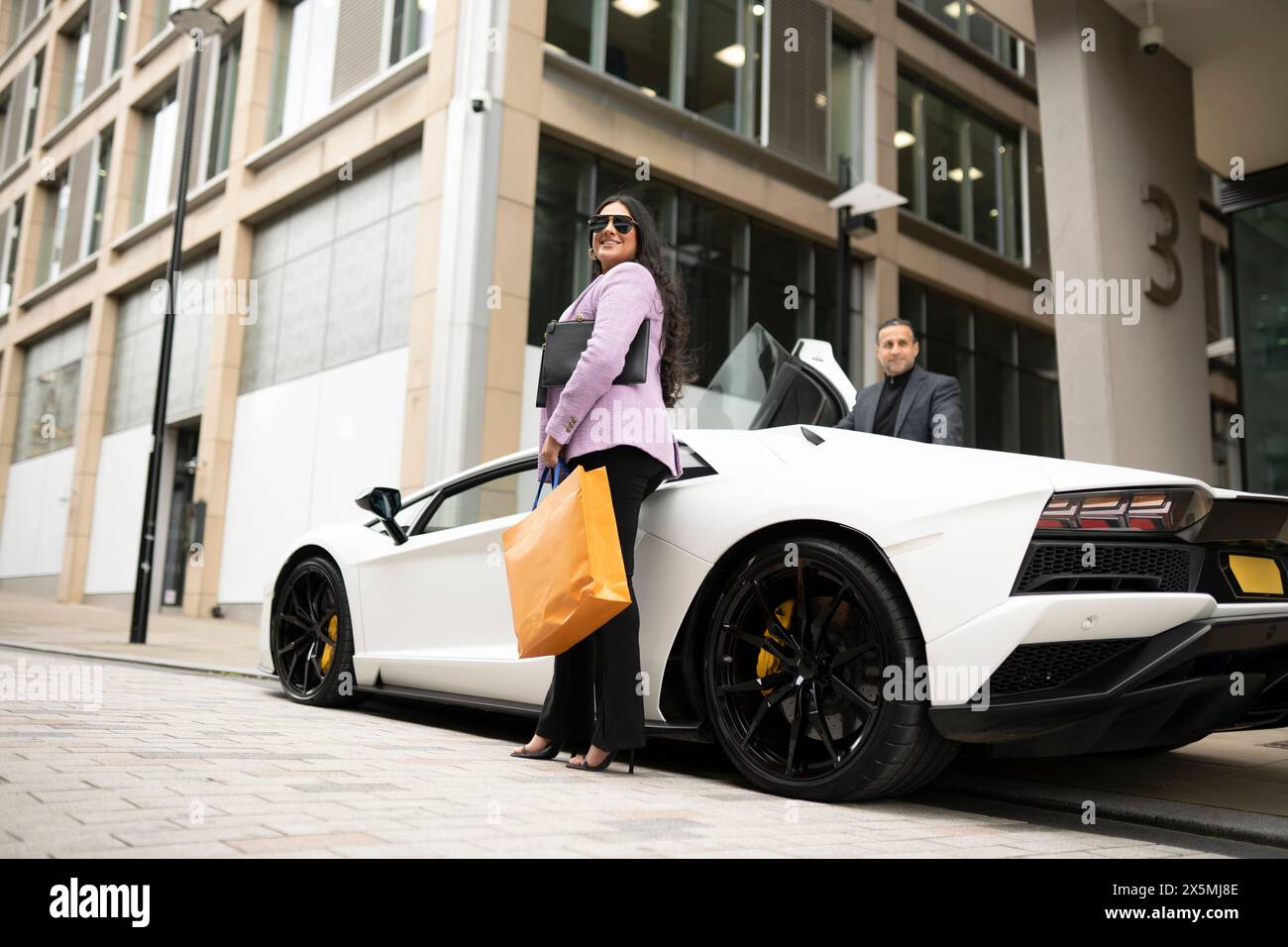 Father and adult daughter getting in luxury car Stock Photo - Alamy