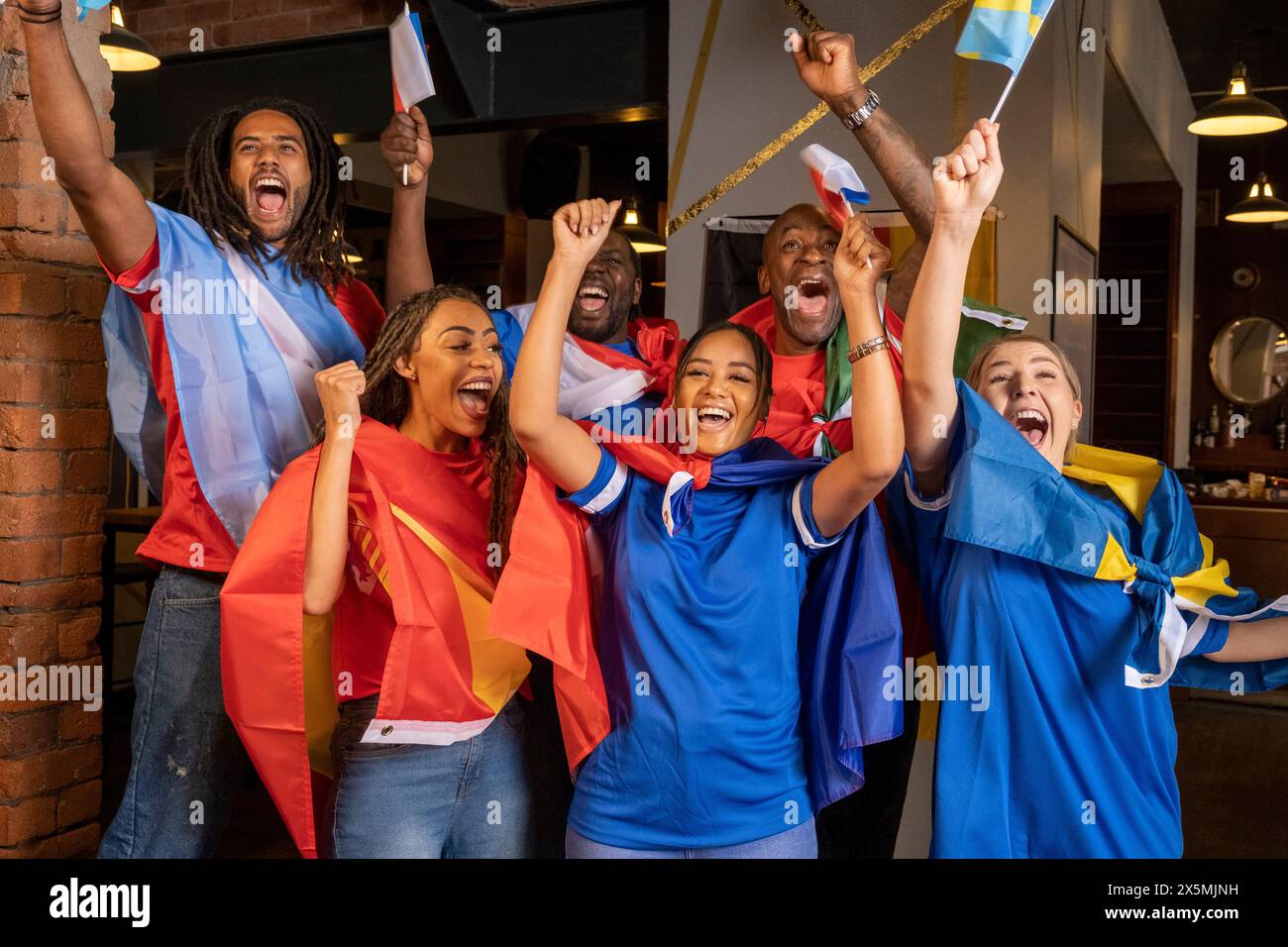 Friends dressed in national flags celebrating world cup competition ...
