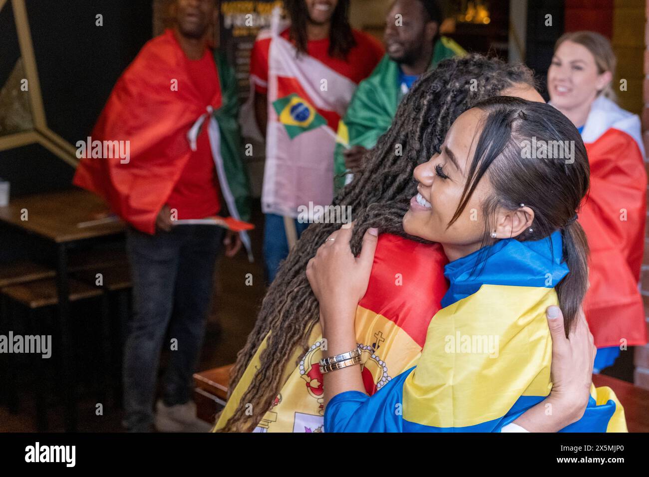 Friends dressed in national flags celebrating world cup competition ...