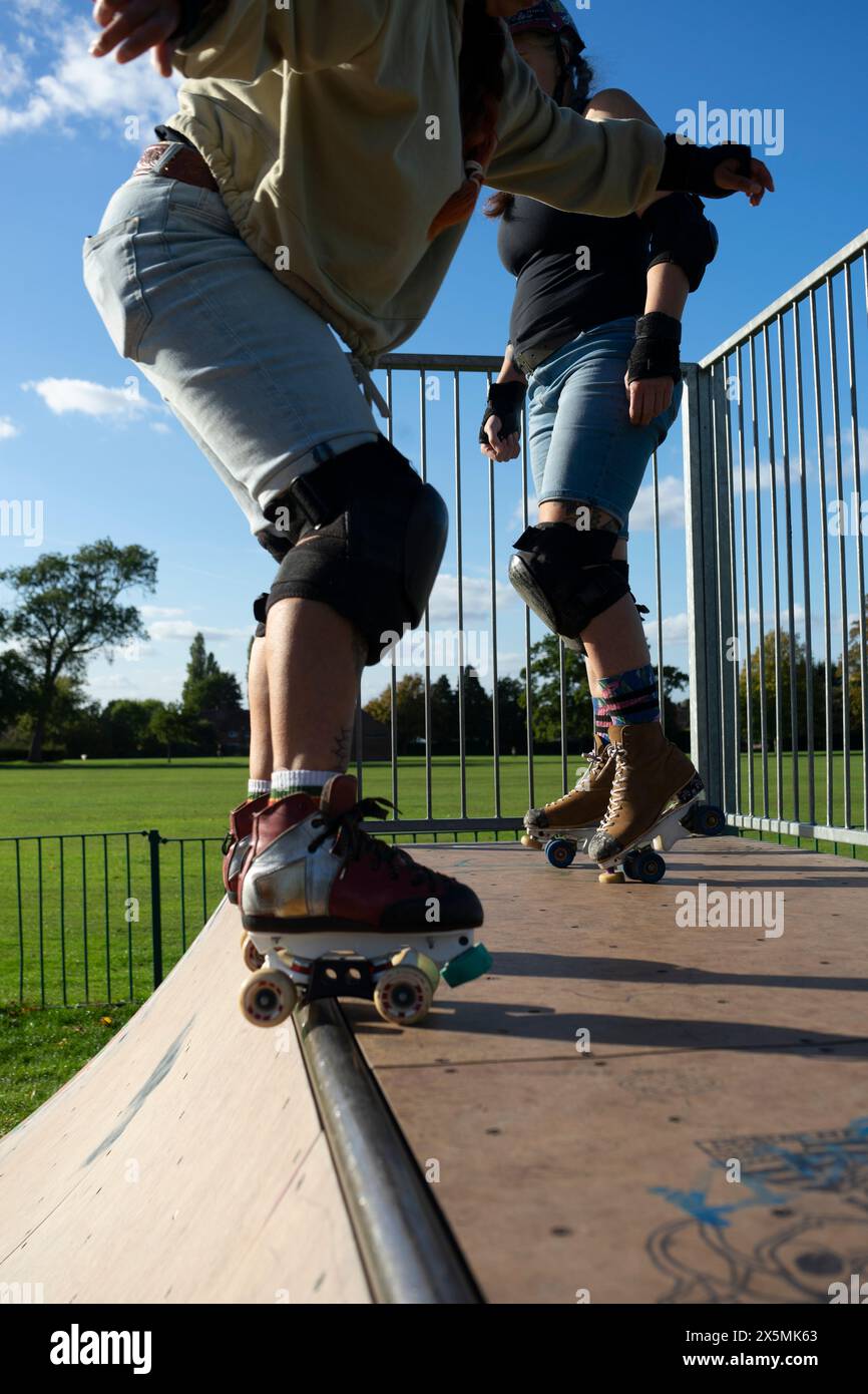 Low section of two women roller-skating?on ramp Stock Photo - Alamy