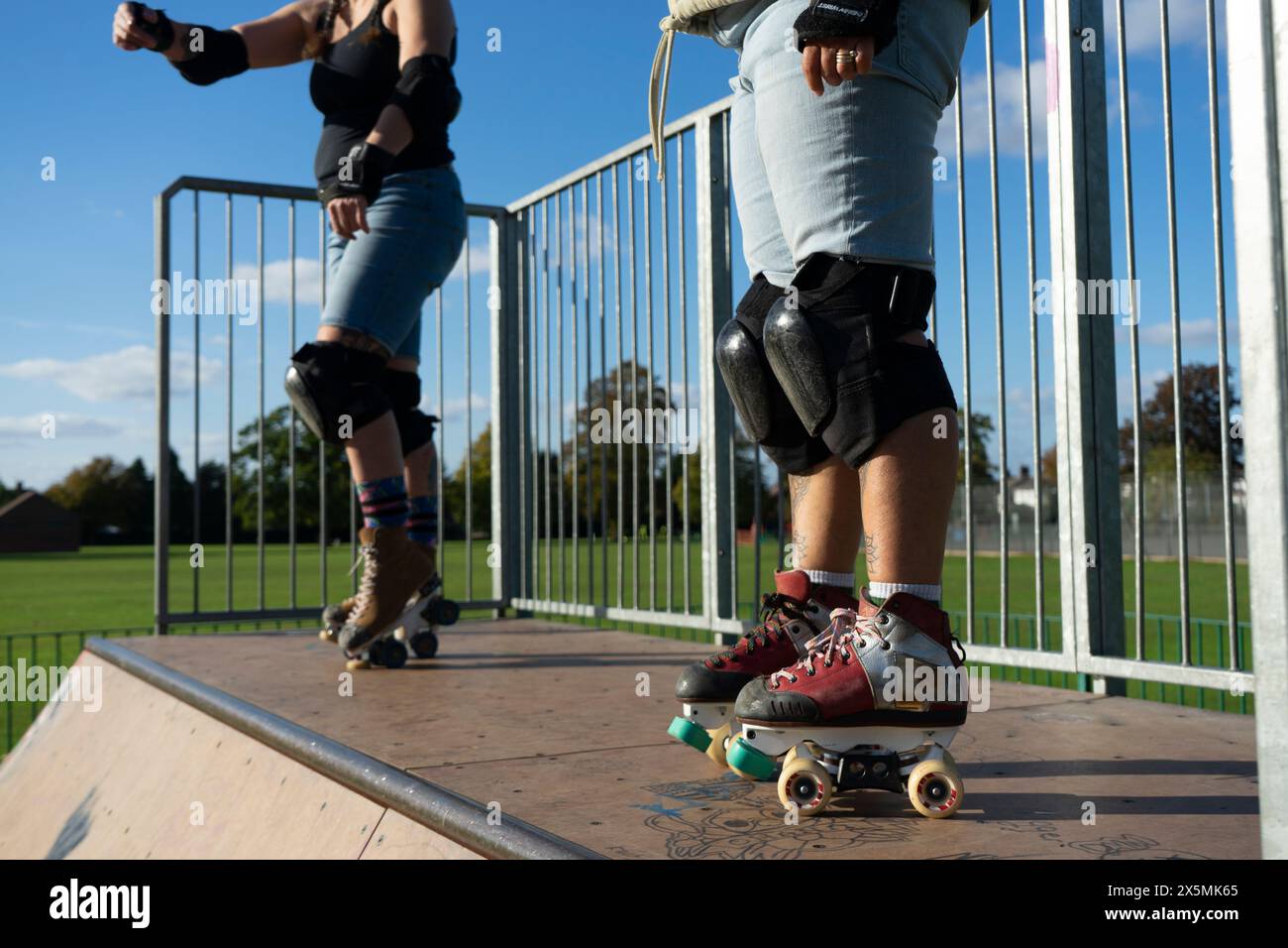 Low section of two women roller-skating on ramp Stock Photo - Alamy