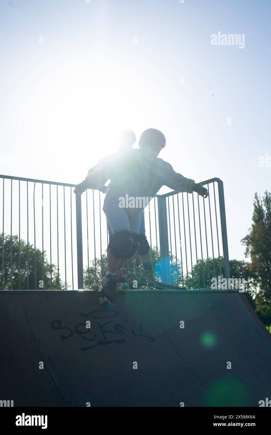 Silhouette of two women roller-skating on ramp Stock Photo - Alamy