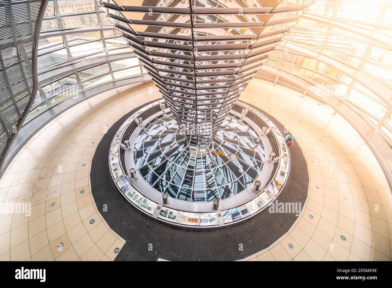 The intricate metal spiral ramp leading upwards inside the modern glass ...