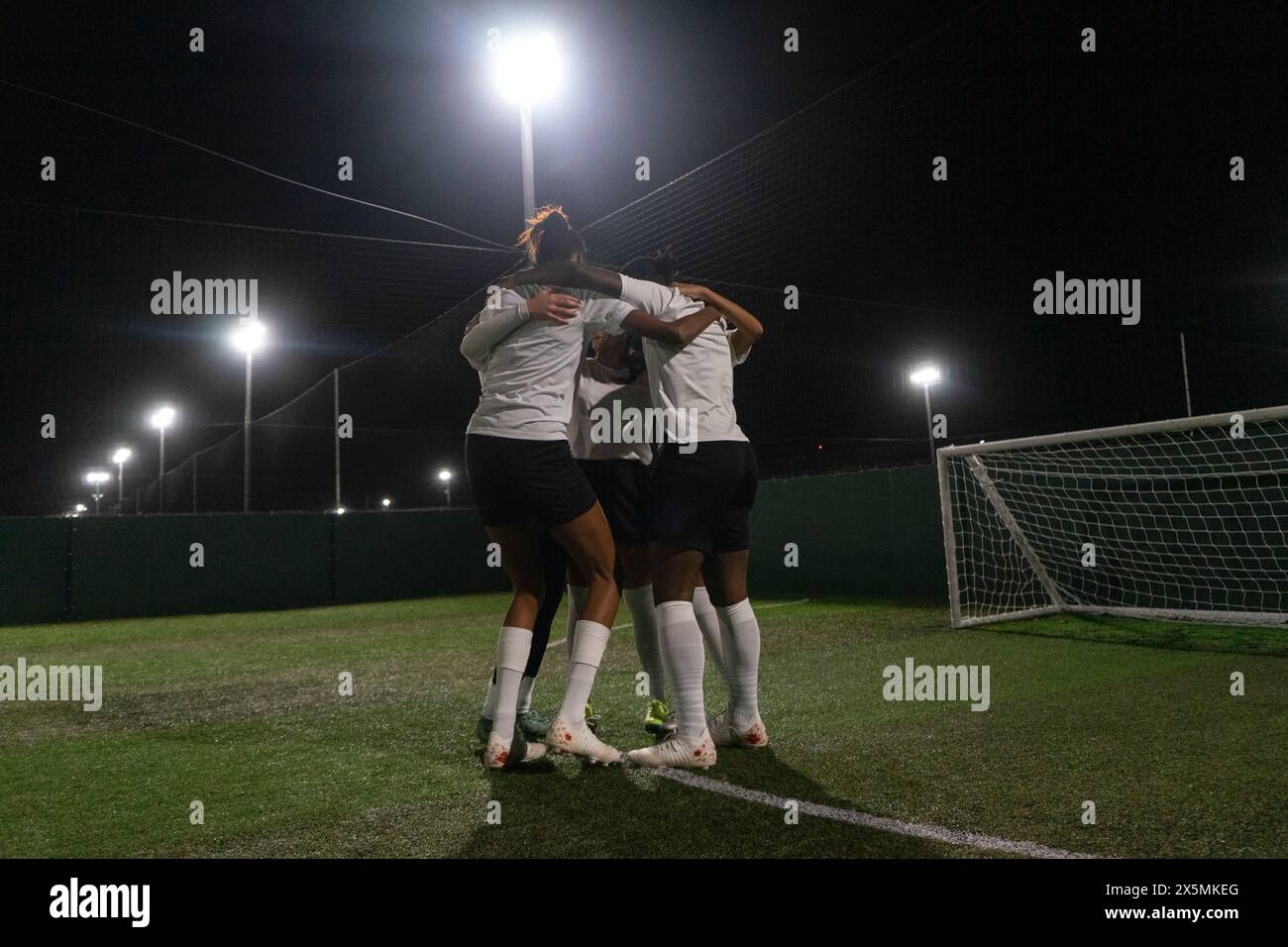 Female soccer players teaming up Stock Photo - Alamy