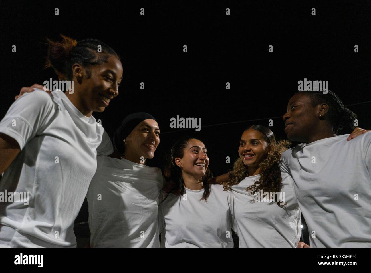 Female soccer players teaming up Stock Photo - Alamy
