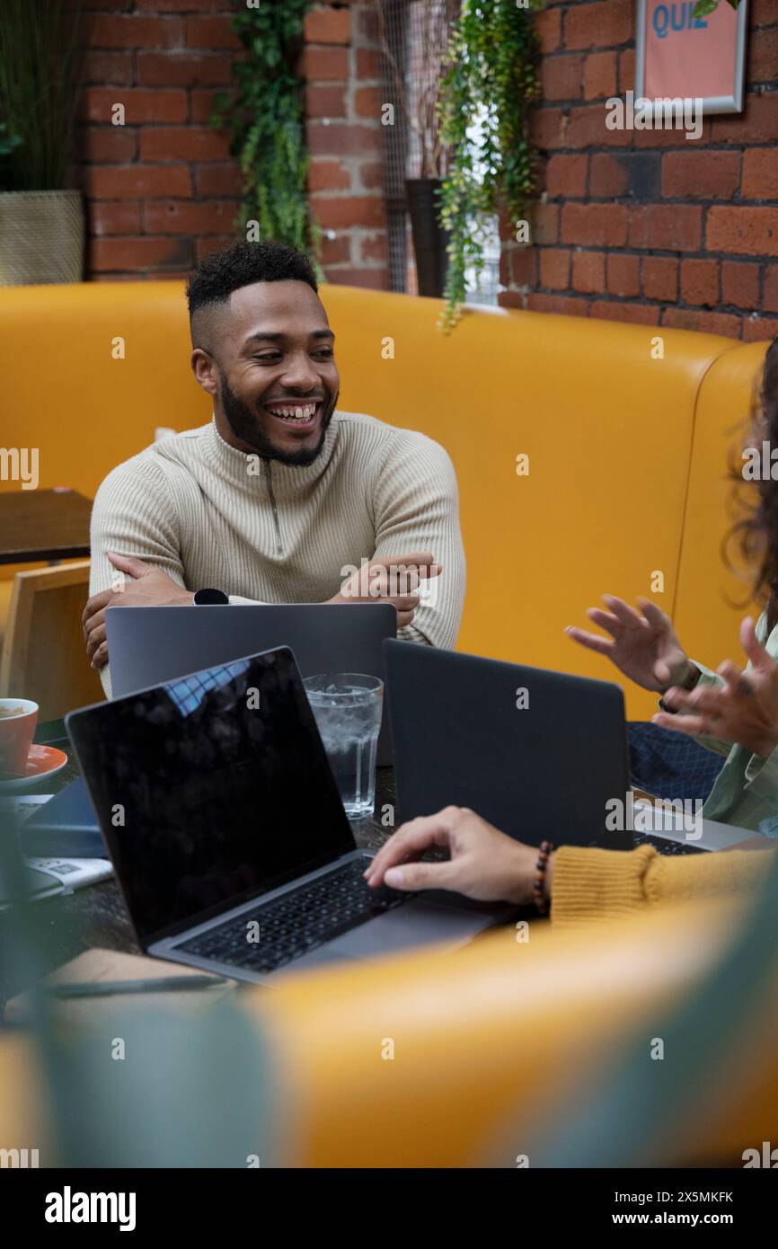 People using laptops in?coworking space Stock Photo - Alamy