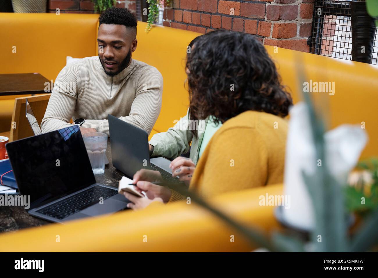 People using laptops in?coworking space Stock Photo - Alamy