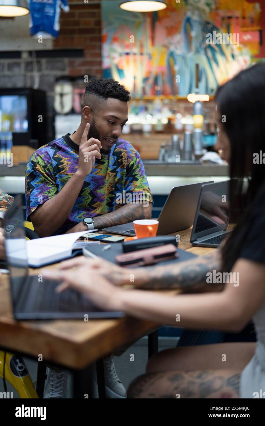 Creative professionals working together in cafeteria Stock Photo - Alamy Creative professionals working together in cafeteria Stock Photo - Alamy