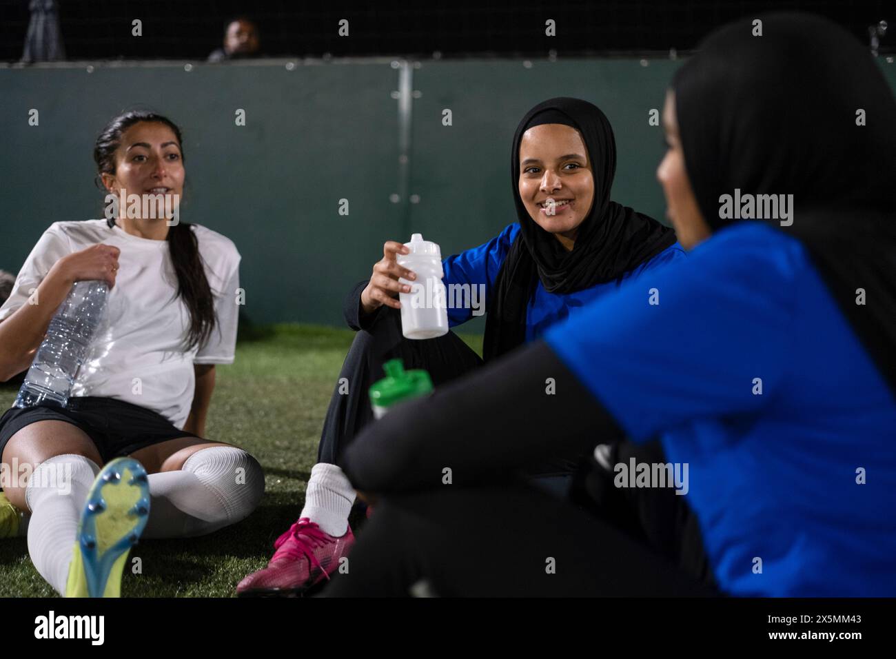 Female soccer players resting Stock Photo - Alamy