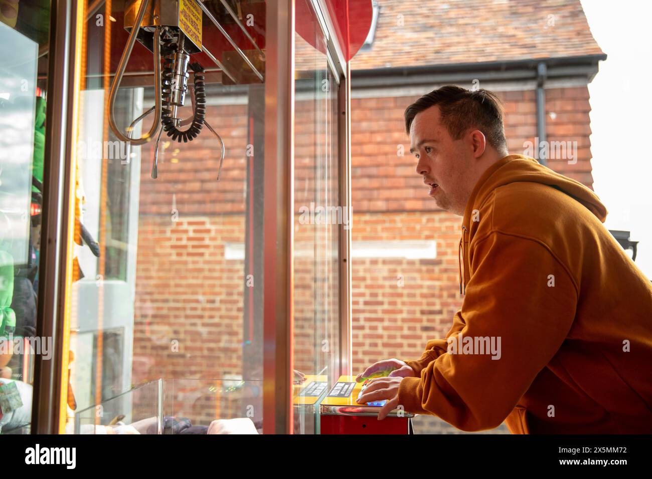 Man at toy grabbing game Stock Photo - Alamy