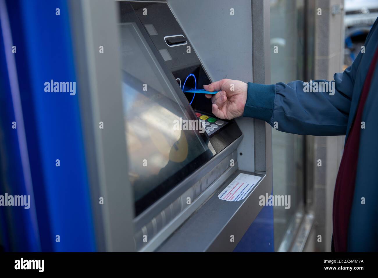 Man using debit card in cash machine, close up Stock Photo - Alamy