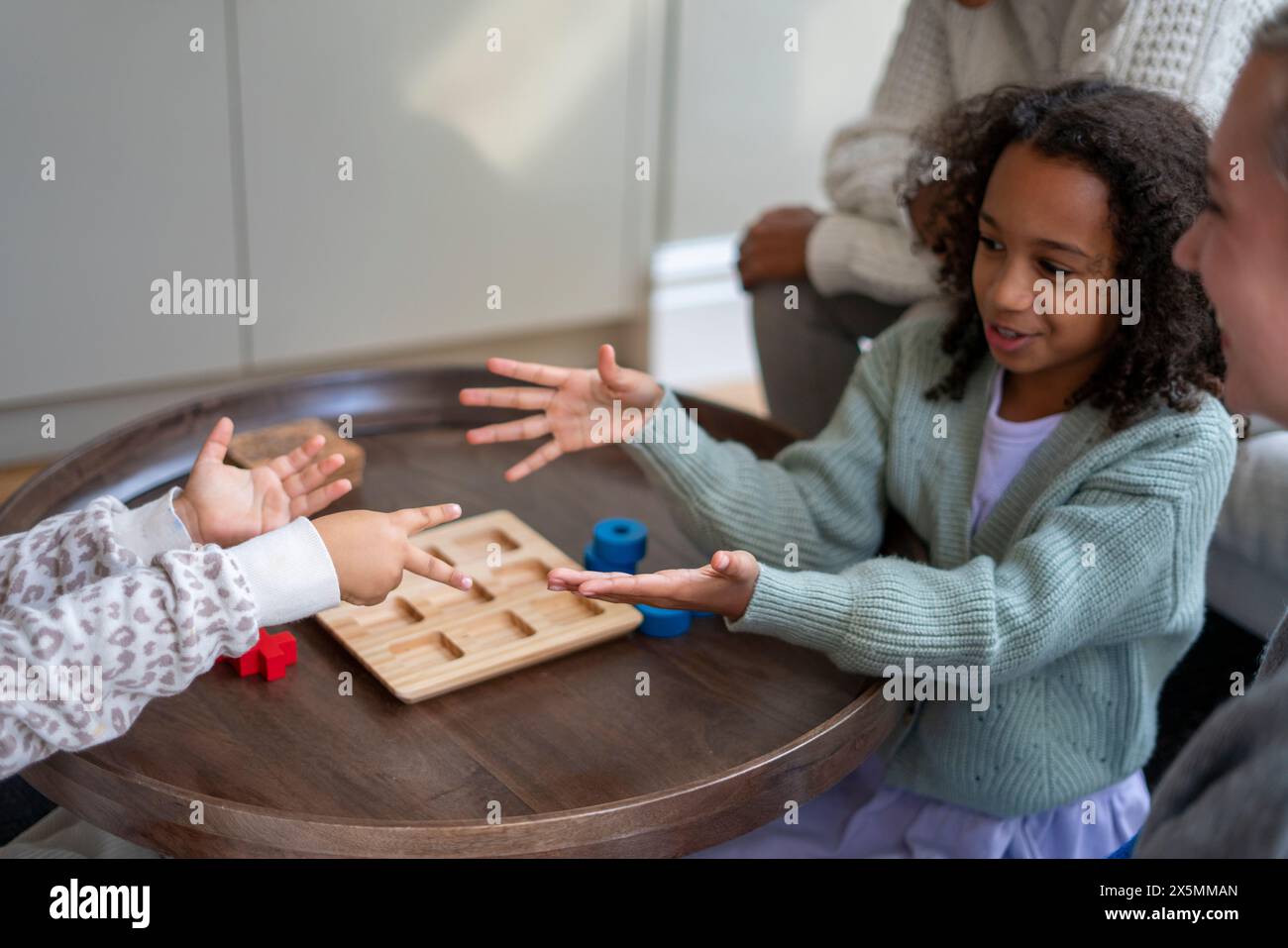 Smiling girls playing rock paper scissors Stock Photo - Alamy