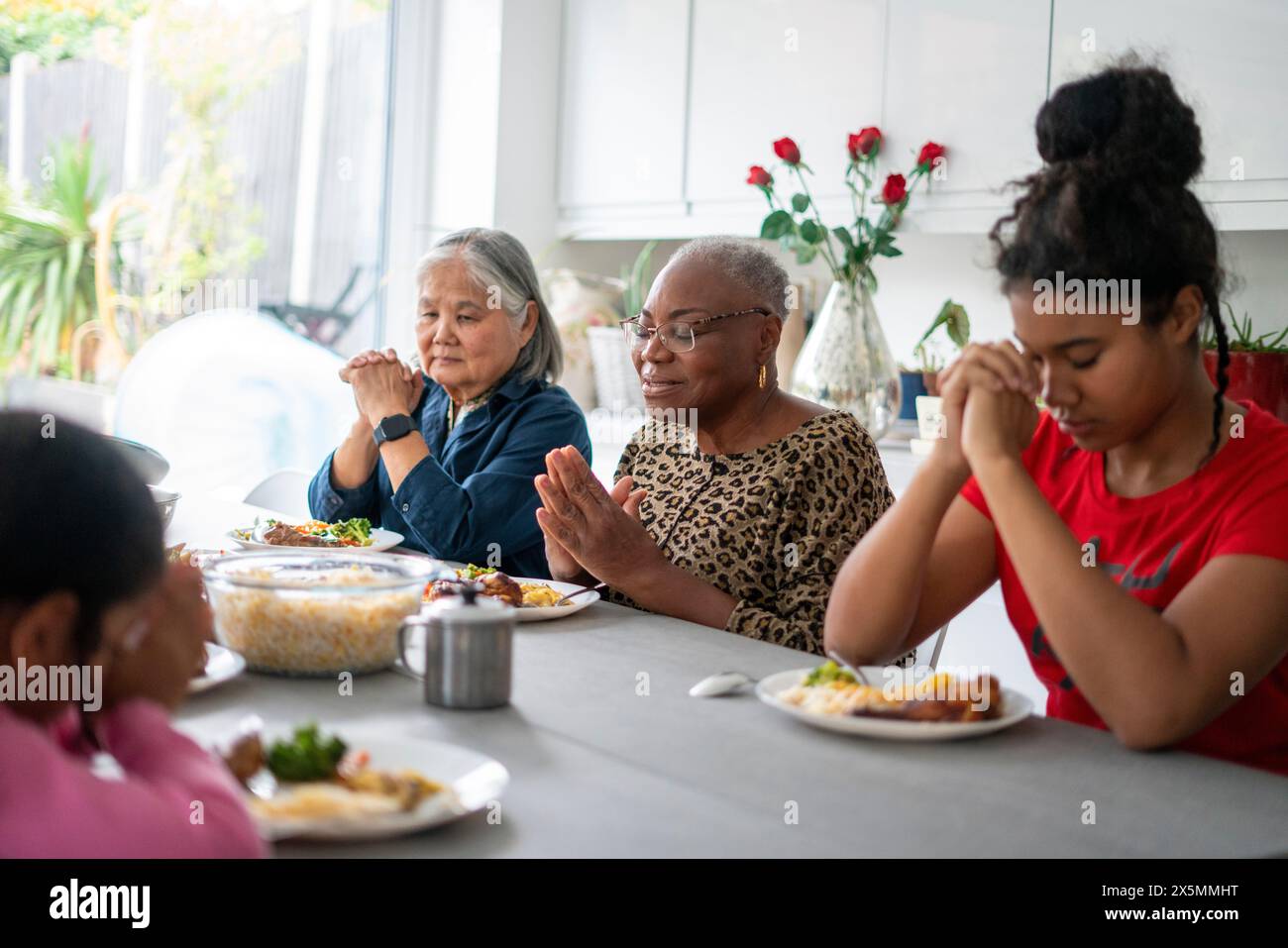 Family praying before eating dinner Stock Photo - Alamy